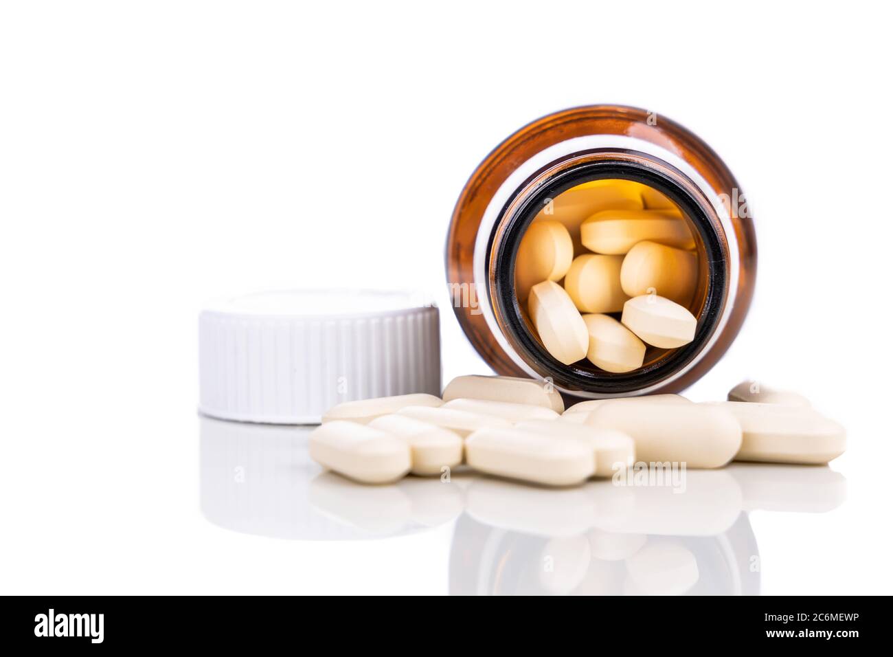 Supplement or medicine in caplet format with opaque glass bottle on ...