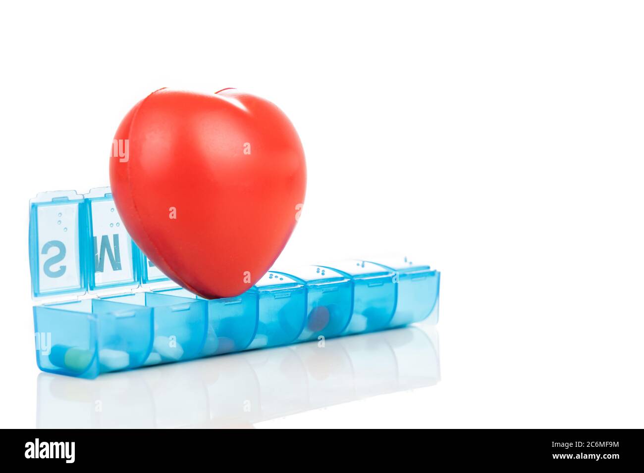 Healthcare concept with pill organizer box for storing doses of daily ...