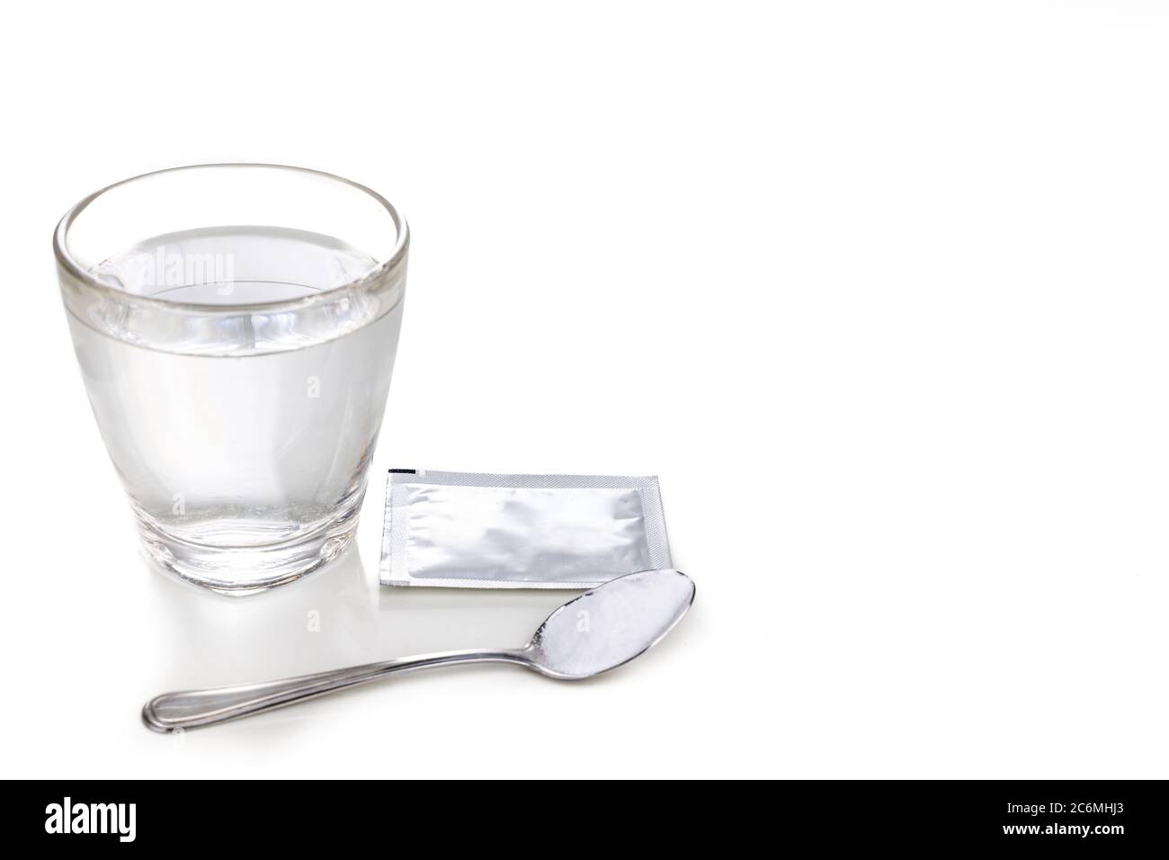 ORS or oral rehydration salt with glass of water, sachet and spoon with ...