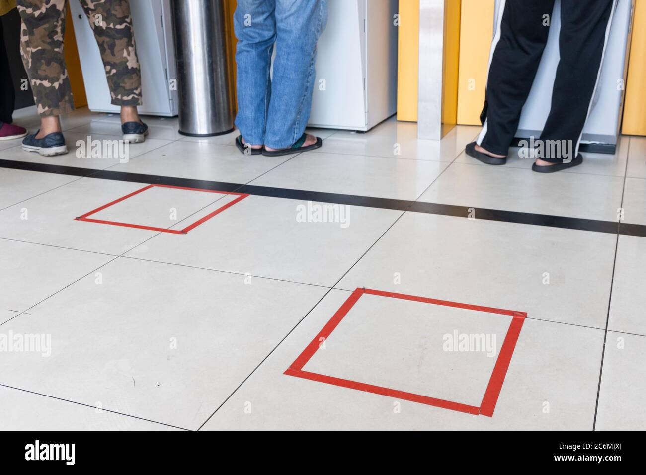 People practicing social distancing in queue towards auto teller ...