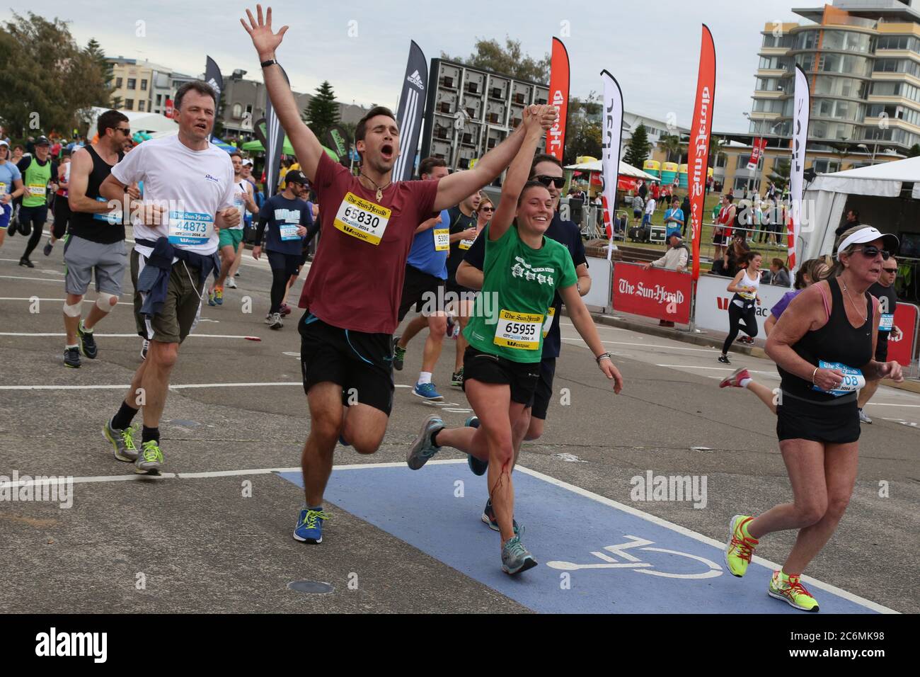 2014 City2Surf runners as they approach the finish line at Bondi Beach ...