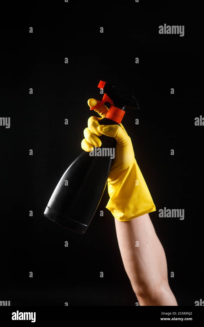 cleaning products, black wiper in hands with yellow rubber gloves Stock ...