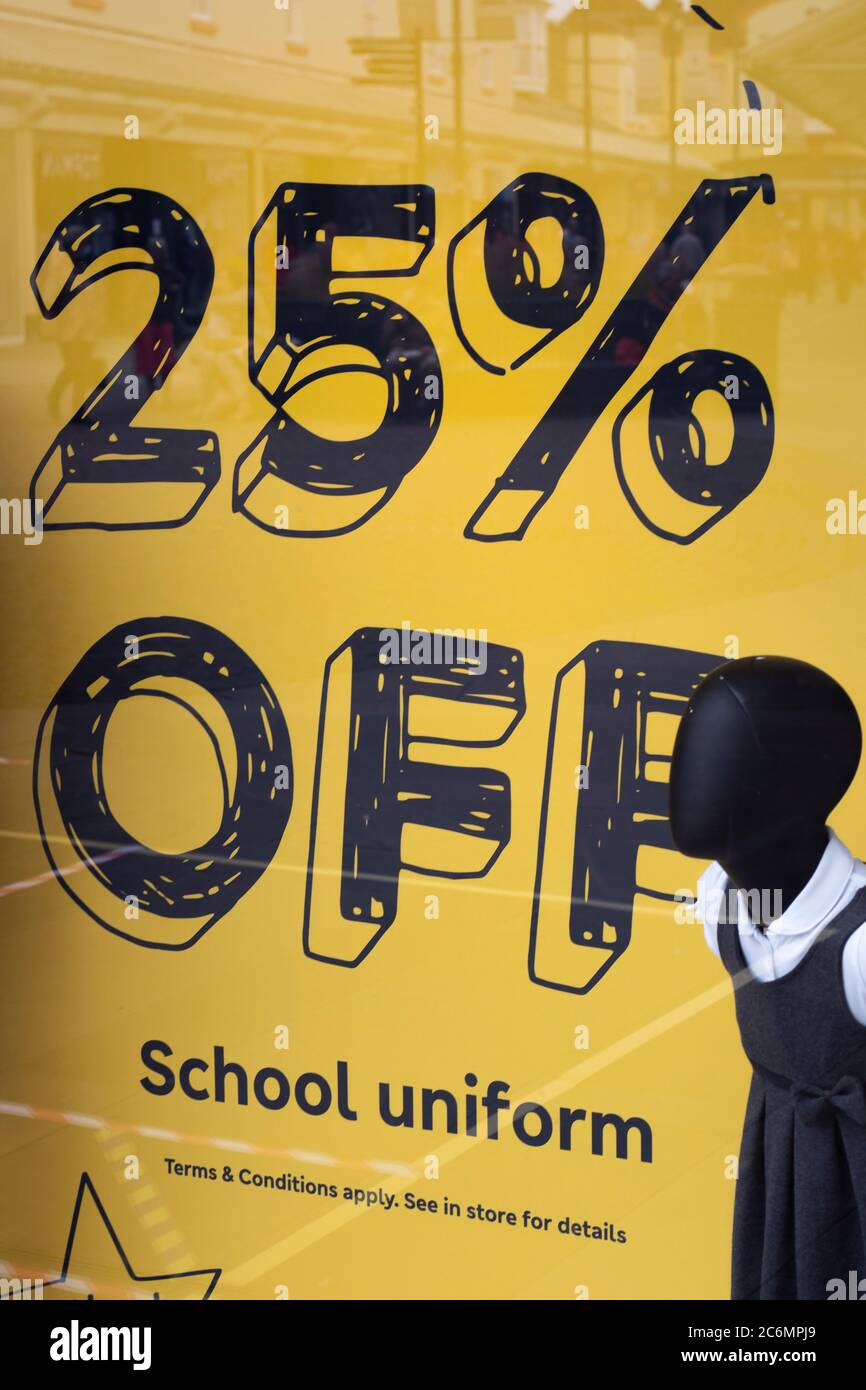 Children school uniform sale sign in store window reduced by twenty ...