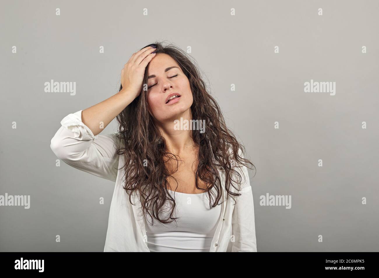 Stress or a headache grimacing in pain holds the back of neck ...