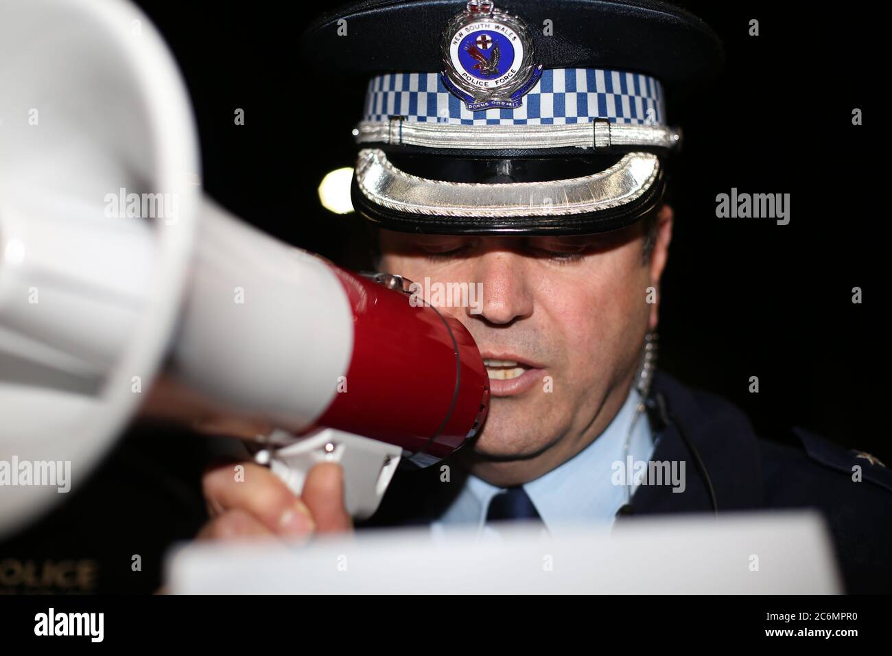 A policeman makes an announcement to protesters at the pro-Palestine ...