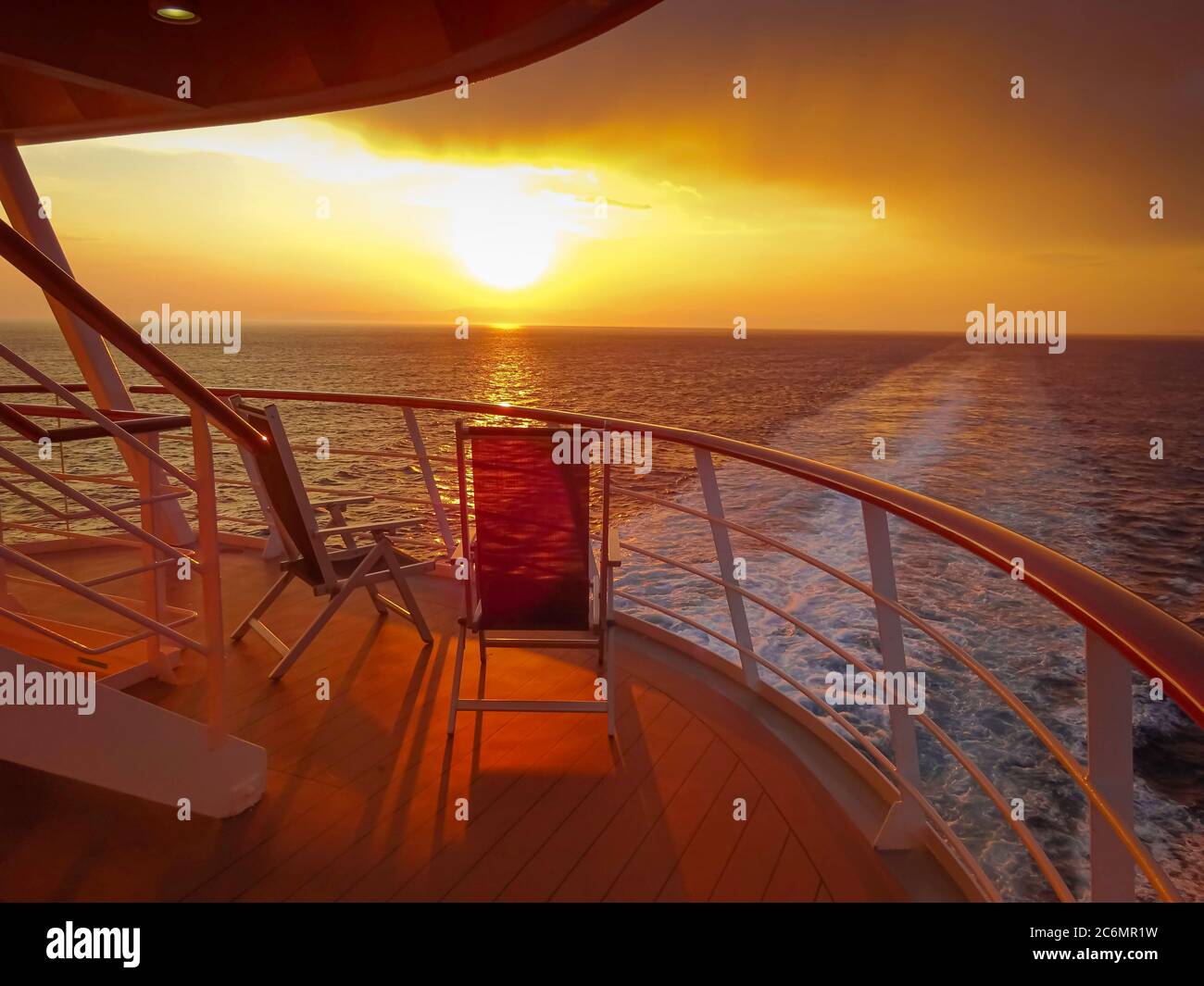 Sunset in the wake of a cruise ship. View from the stern of the ship ...