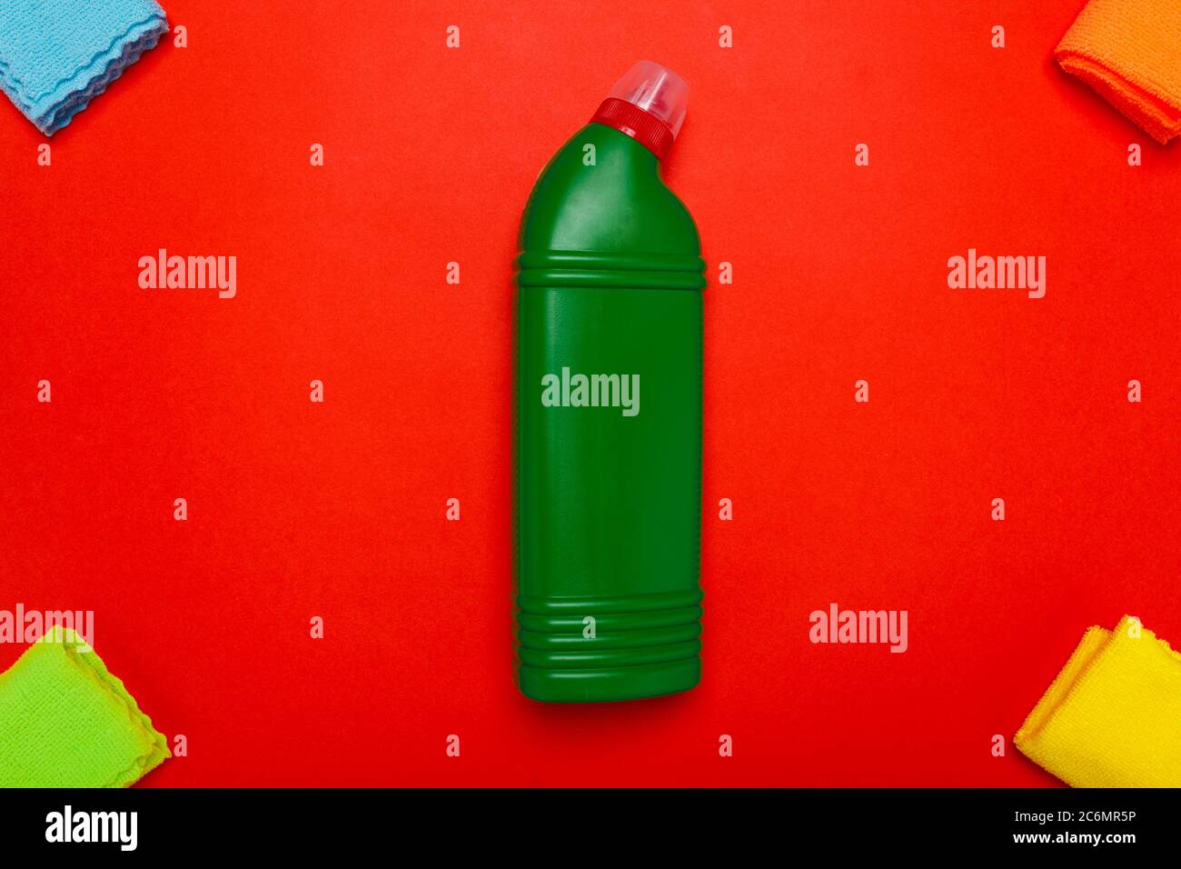 yellow toilet cleaner with rags on a red background Stock Photo - Alamy