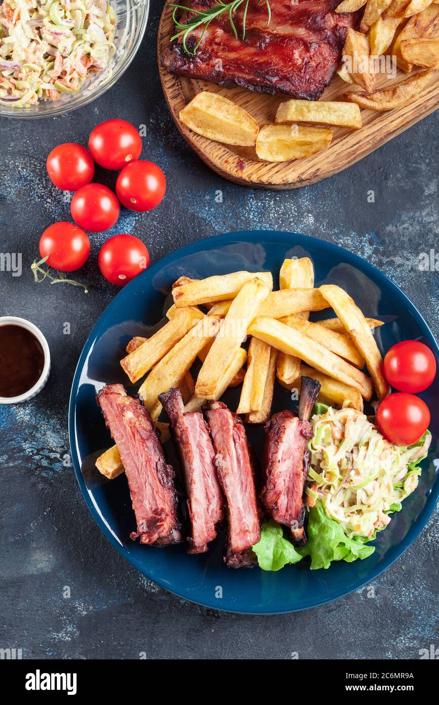 Spicy barbecued pork ribs served with french fries and BBQ sauce Stock ...