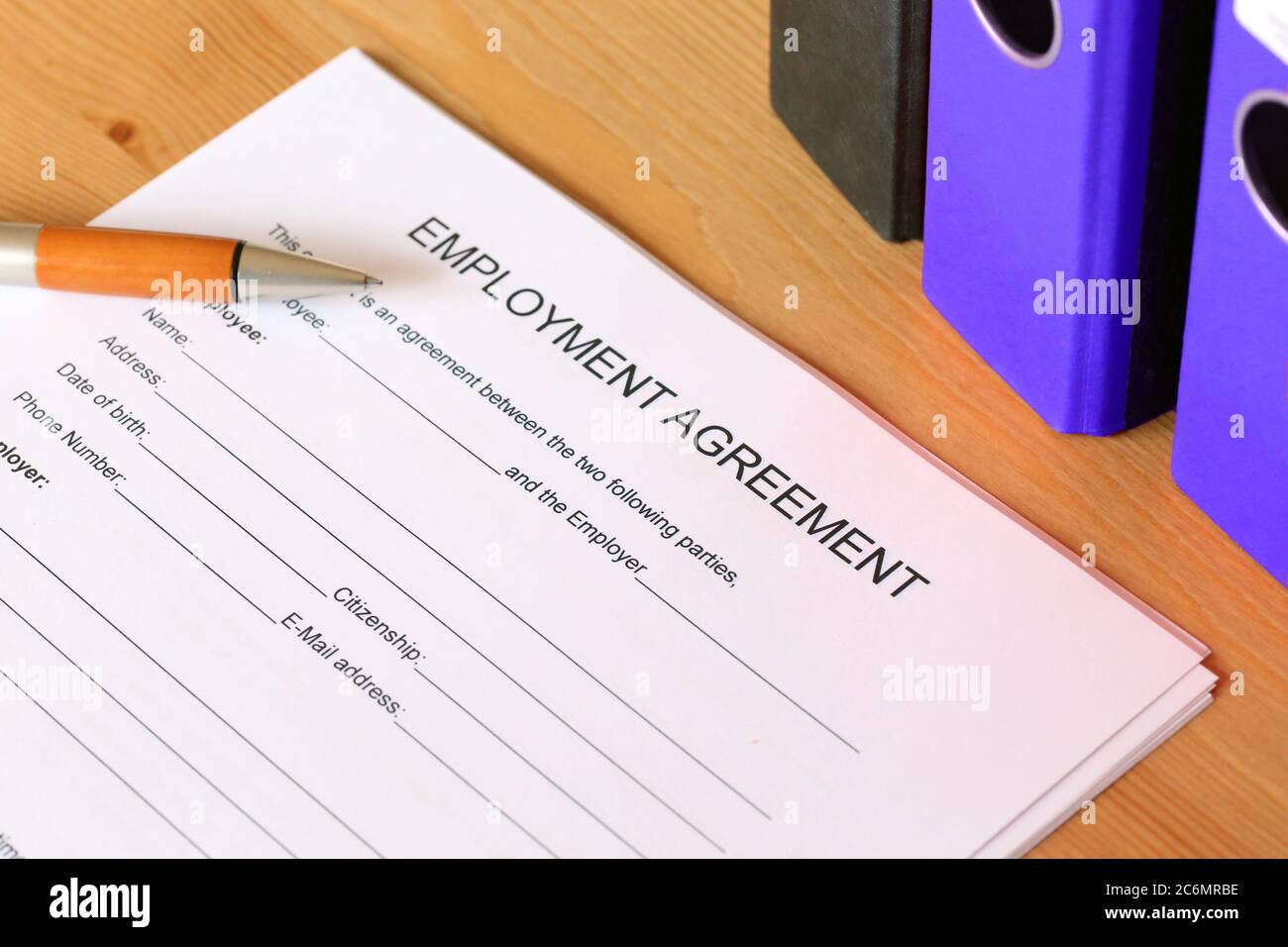 Symbol image: Blank form of an employment agreement on a desk Stock ...
