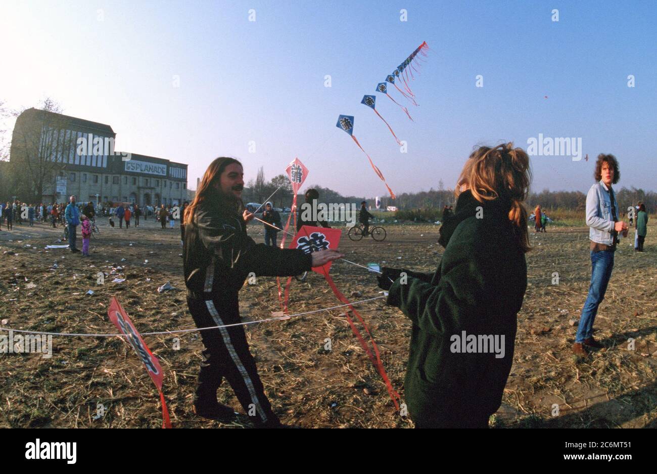 East Germans fly kites as they celebrate the demolition of a section of ...
