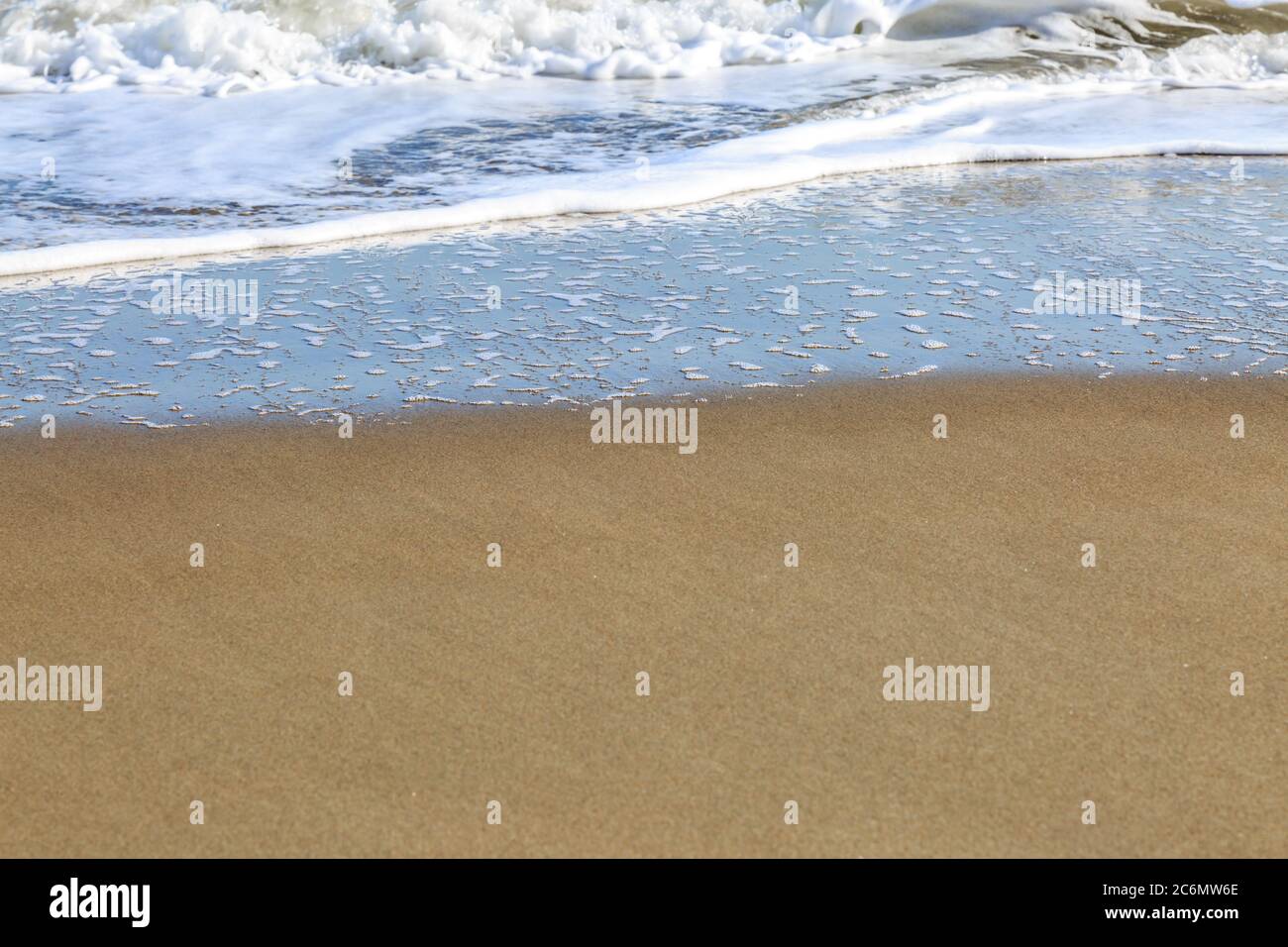 The sea lapping a sandy beach on the Isle of Wight Stock Photo - Alamy