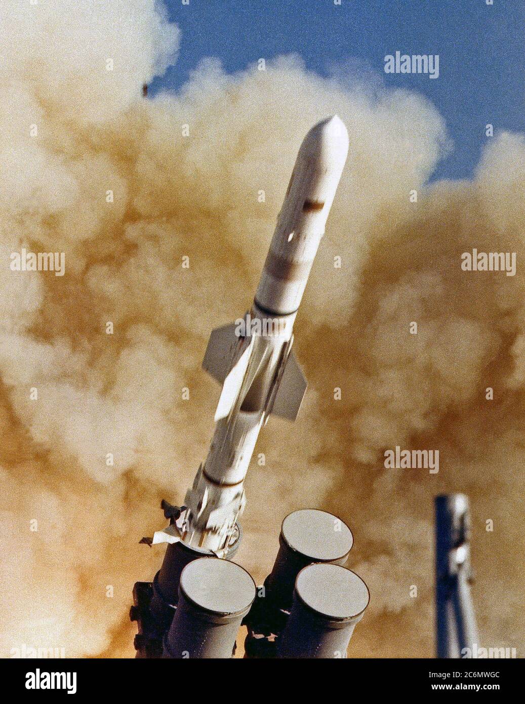 A view of an RGM-84 Harpoon missile being launched from a canister ...