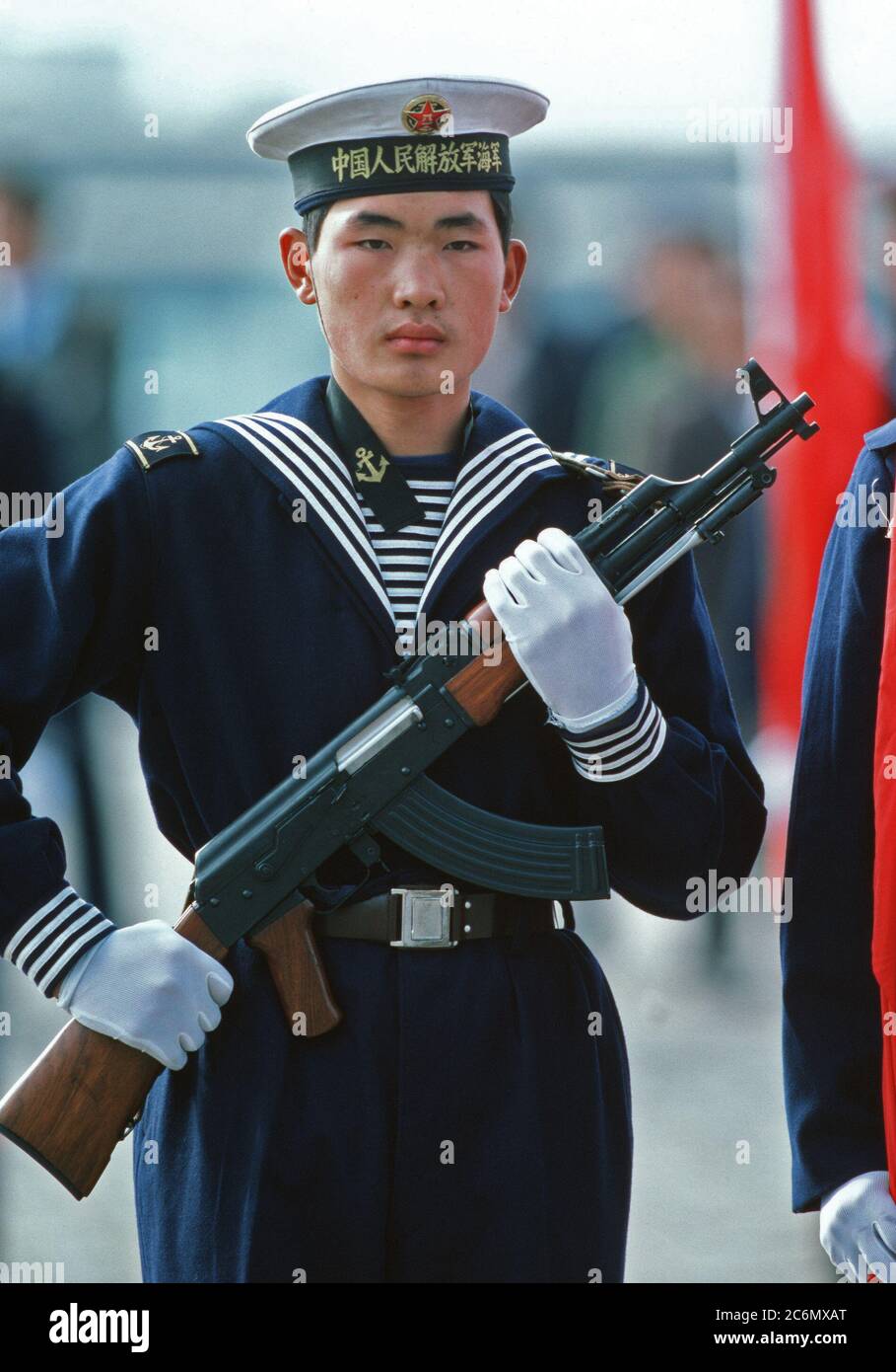 A Chinese sailor, armed with a Type 56 assault rifle, stands watch ...