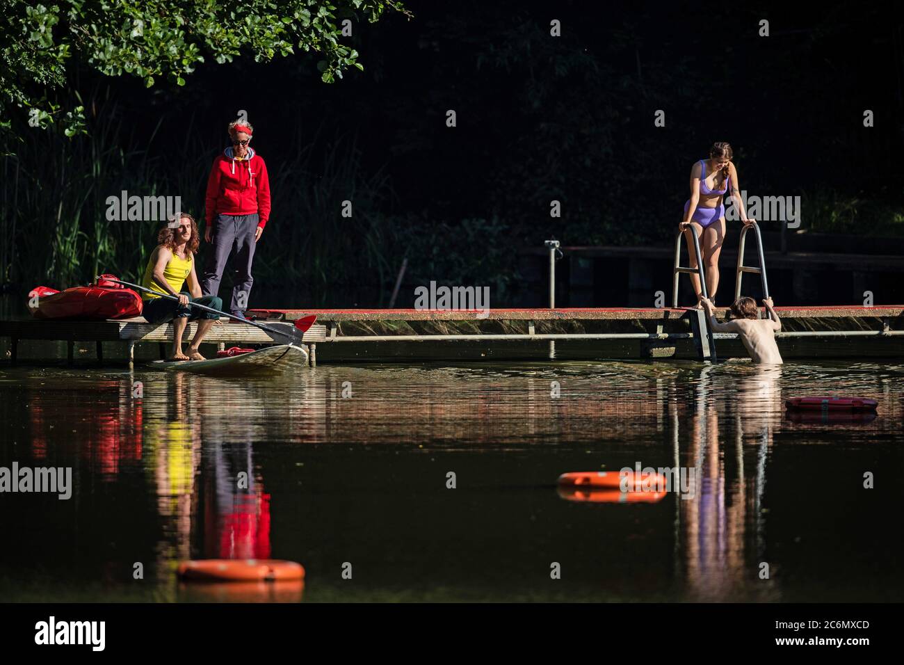 Swimmers enter the Hampstead Heath mixed bathing pond in London as it ...