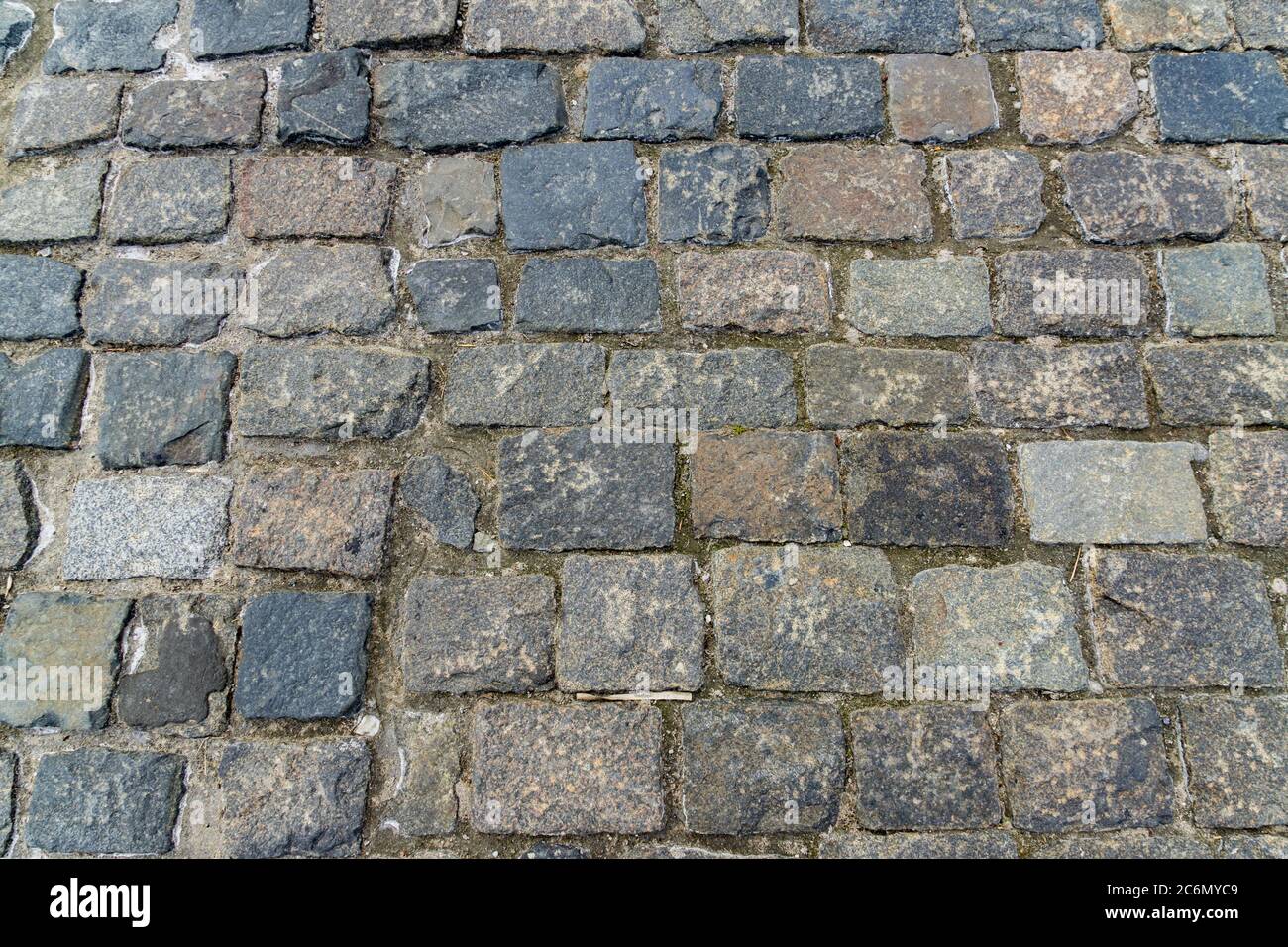 granite stone pavement texture. Abstract background of old cobble stone ...