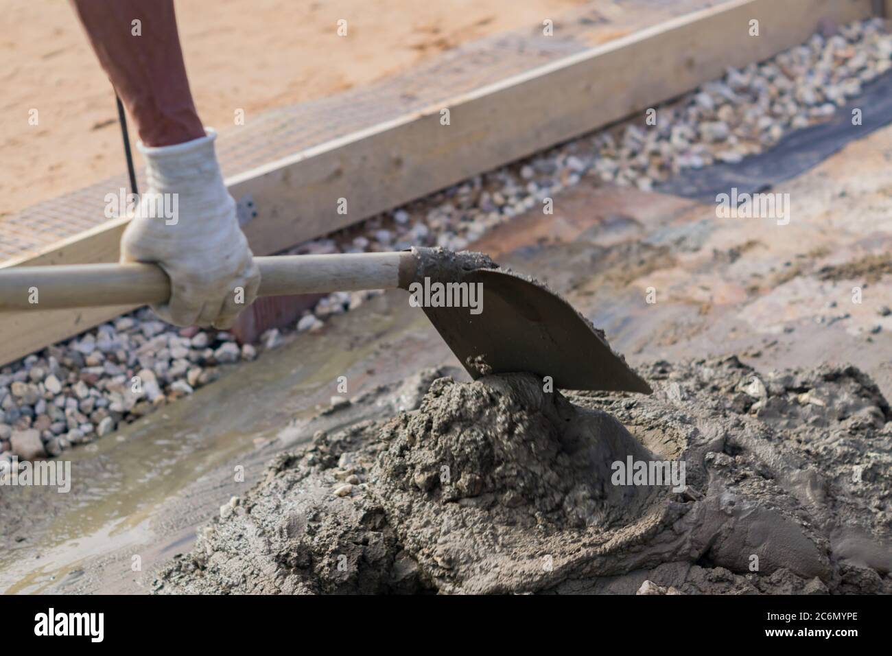 worker mixing concrete and gravel with spade on construction cite Stock ...