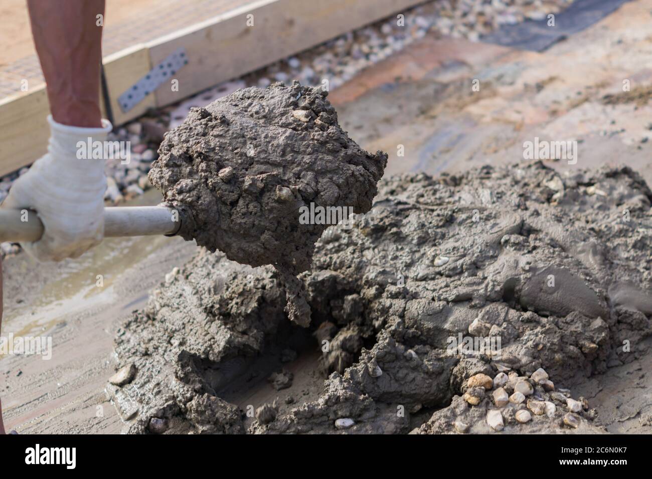 worker mixing concrete and gravel with spade on construction cite Stock ...