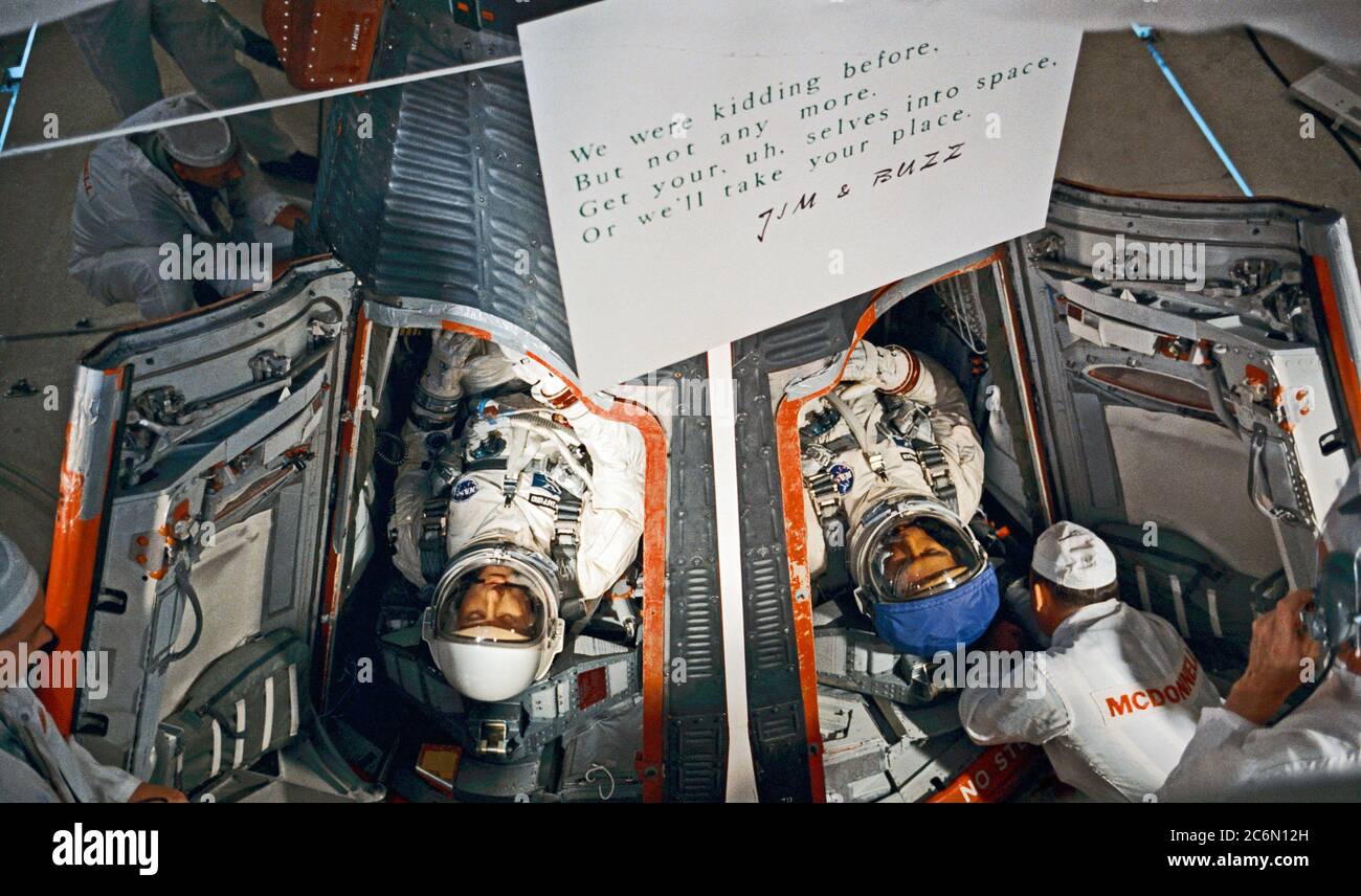 Technicians prepare to close the hatches on the Gemini-9A spacecraft ...