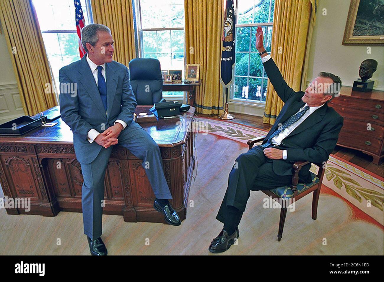 President George W. Bush sits on the edge of his desk Wednesday May 2 ...