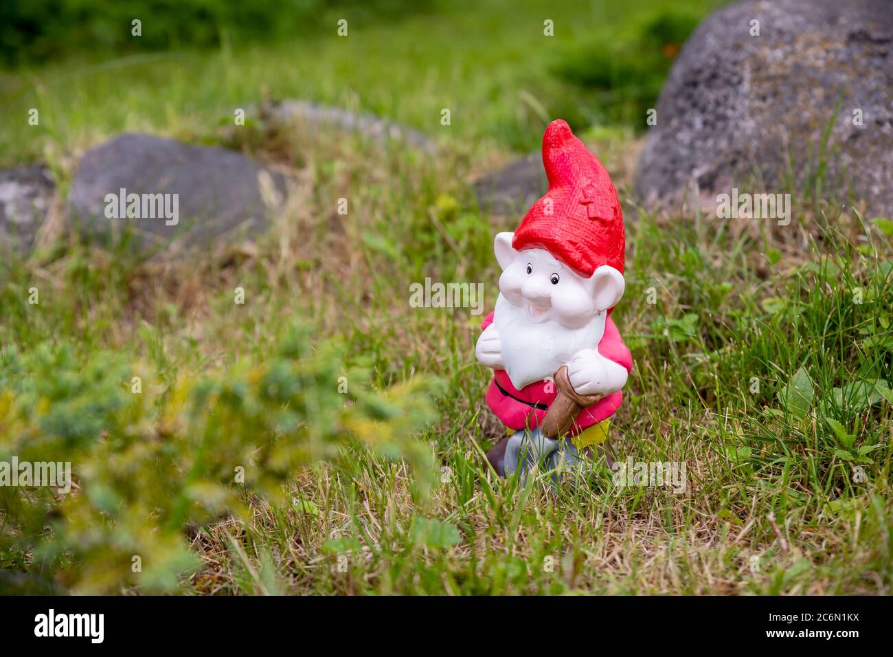 A typical traditional colorful German garden goblin with smiling facial ...