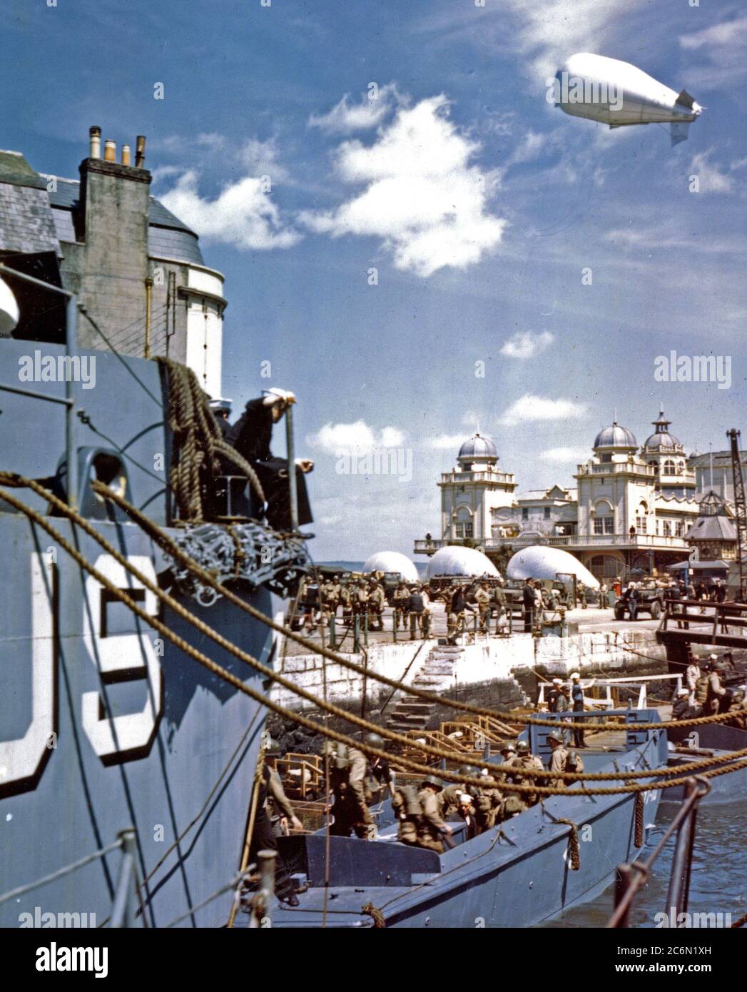 American troops at a British port descend into barges which will take ...