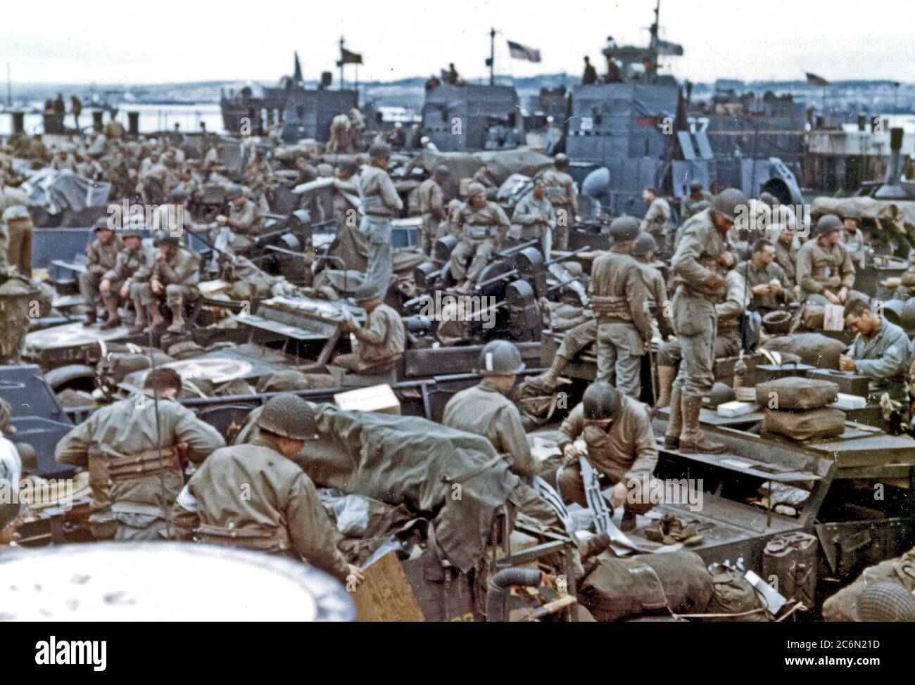 Men and equipment are massed together in landing craft in preparation ...