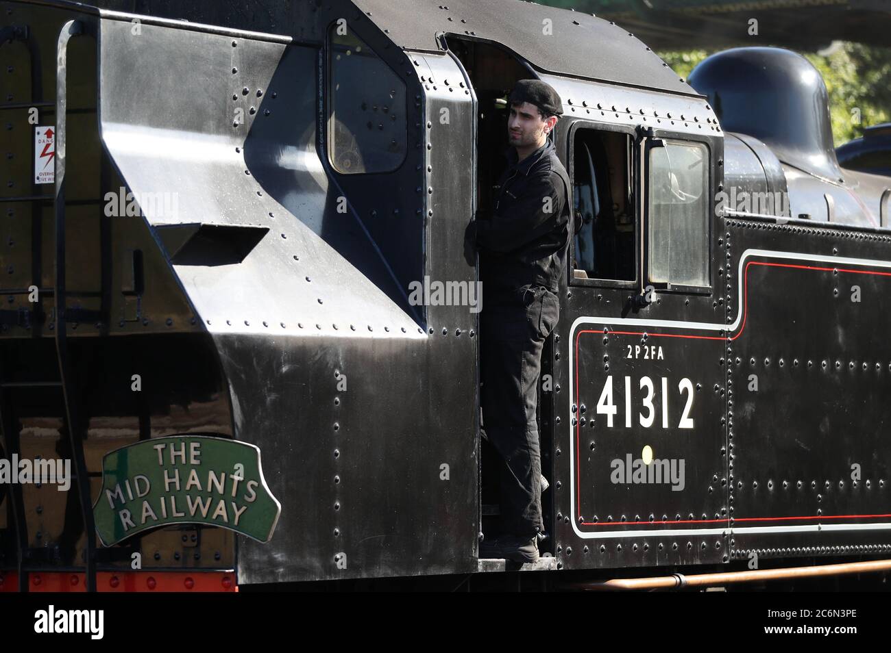 A volunteer looks out of the British Railways Ivatt Class 2MT Tank ...
