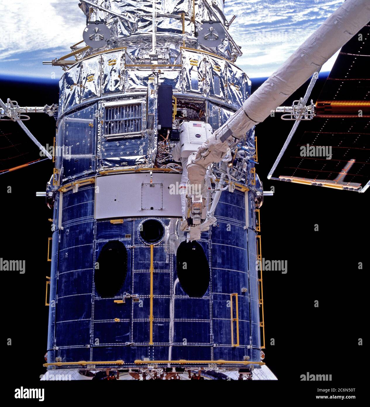 (11-21 Feb. 1997) --- Astronaut Mark C. Lee, standing on the end of the ...