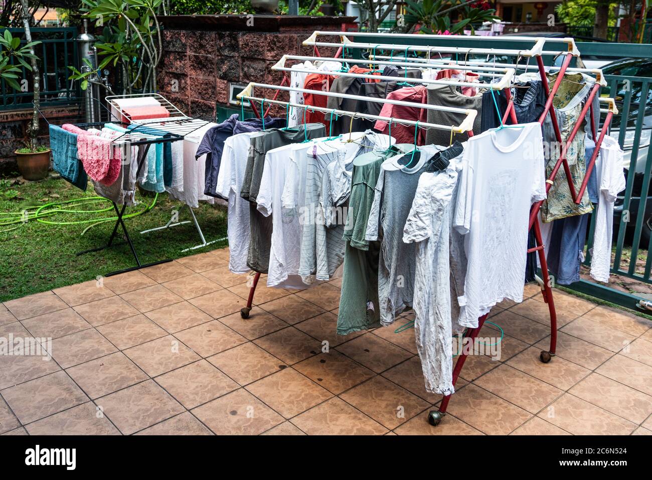 Laundry fabric being dried under bright hot sun in home compound after ...