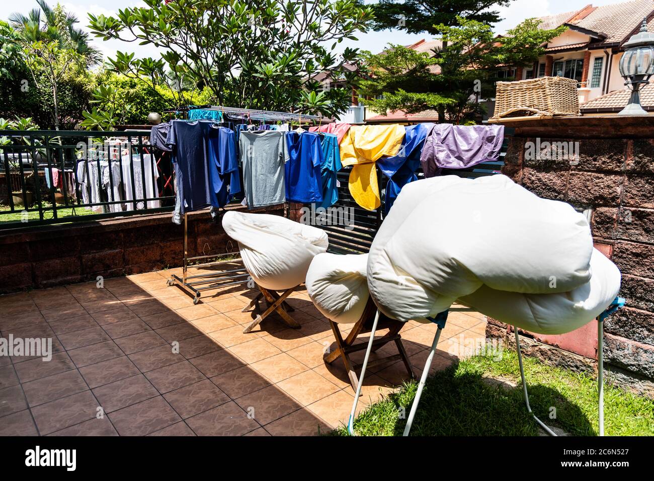Laundry fabric being dried under bright hot sun in home compound after ...
