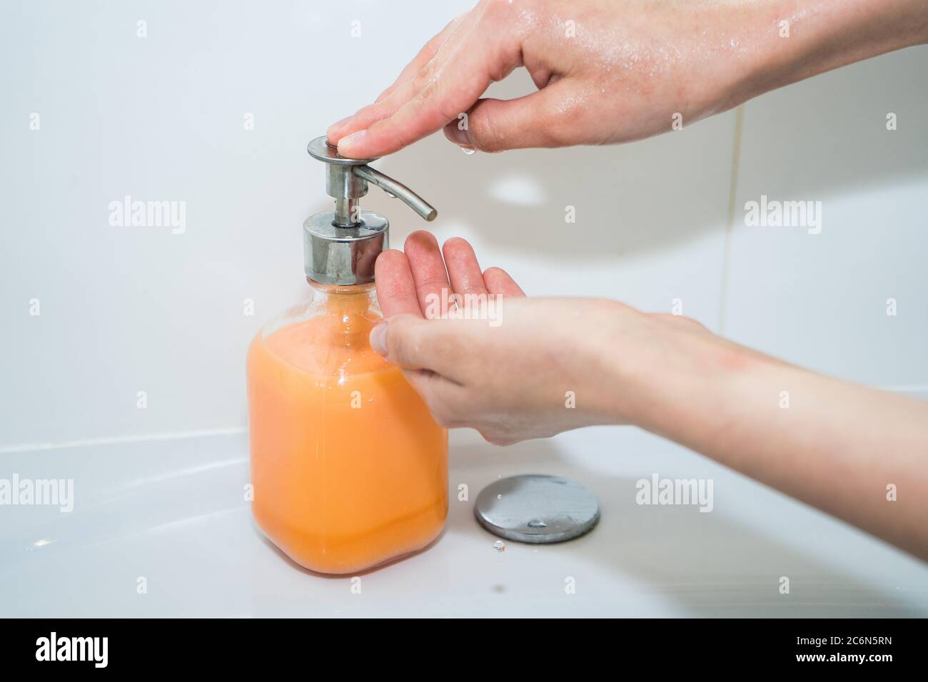 Hand washing with soap. Girl washes her hands with antibacterial soap ...