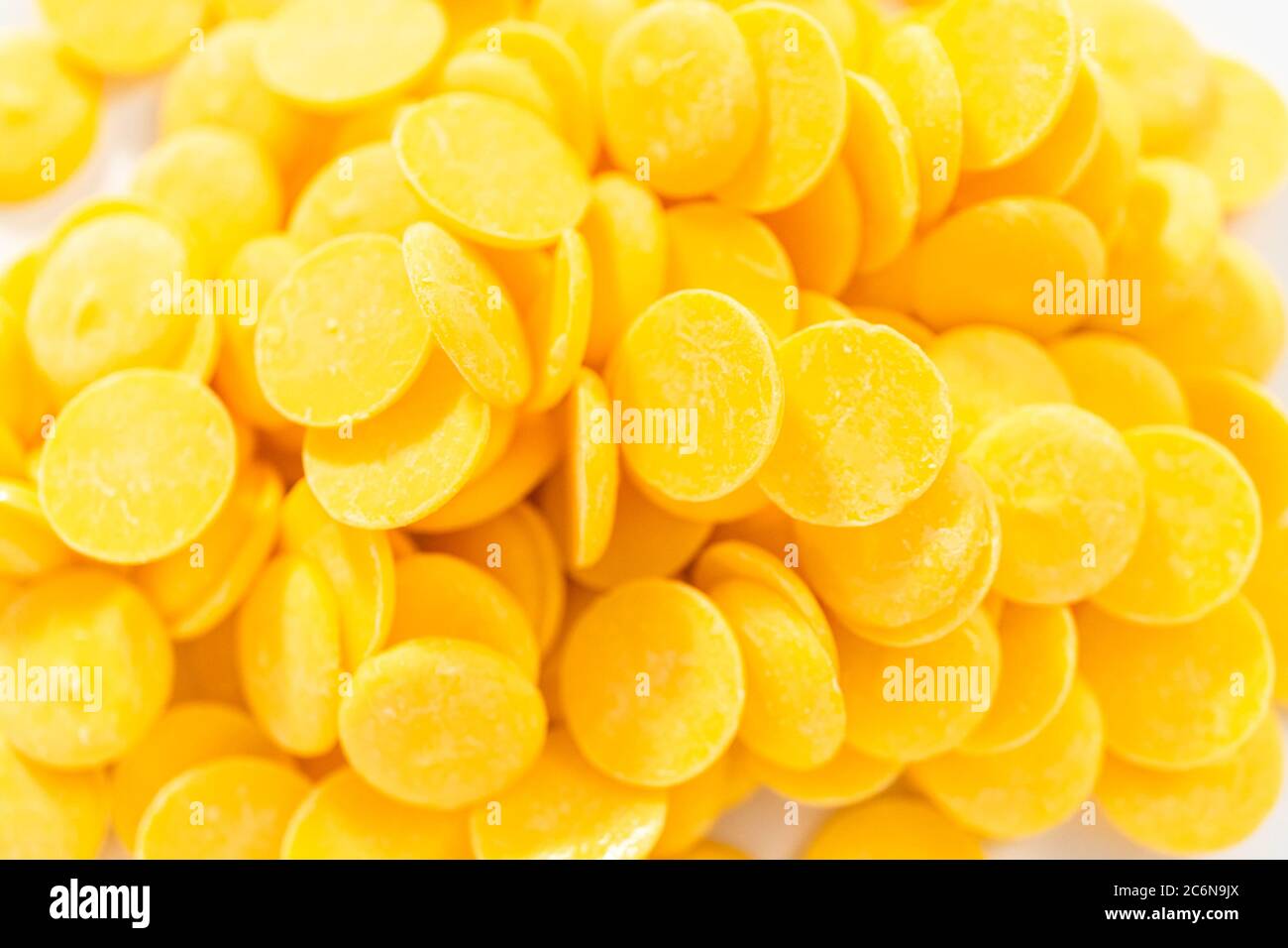 Yellow round chocolate chips for melting chocolate shapes Stock Photo ...