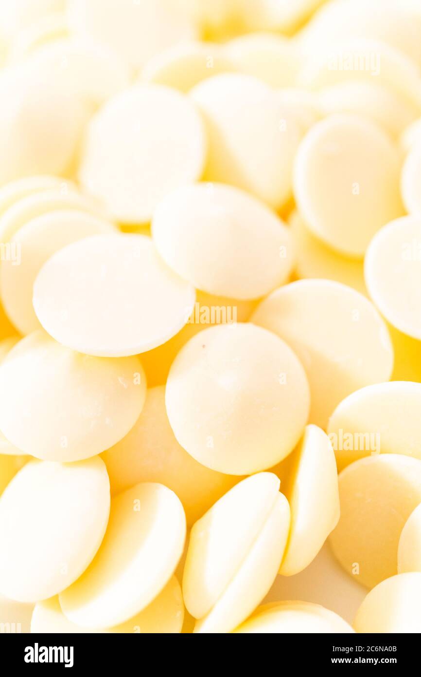White round chocolate chips for melting chocolate shapes on a white ...