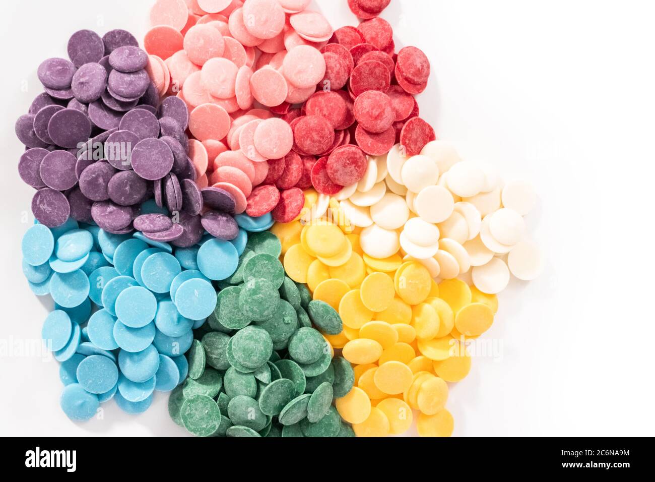 Flat lay. Pink round chocolate chips for melting chocolate shapes on a ...