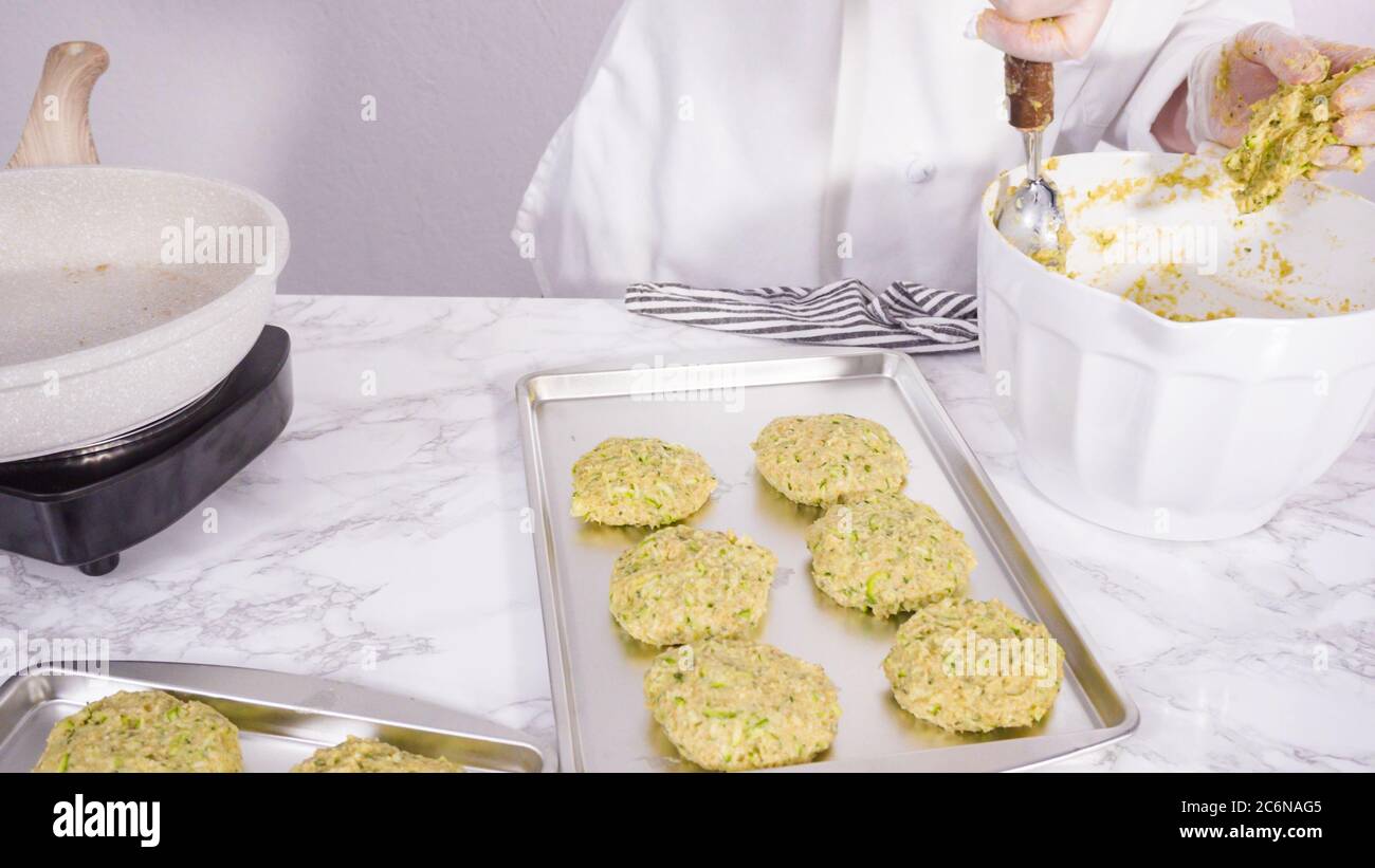 Step by step. Shaping patties of zucchini cakes to fry on a frying pan ...