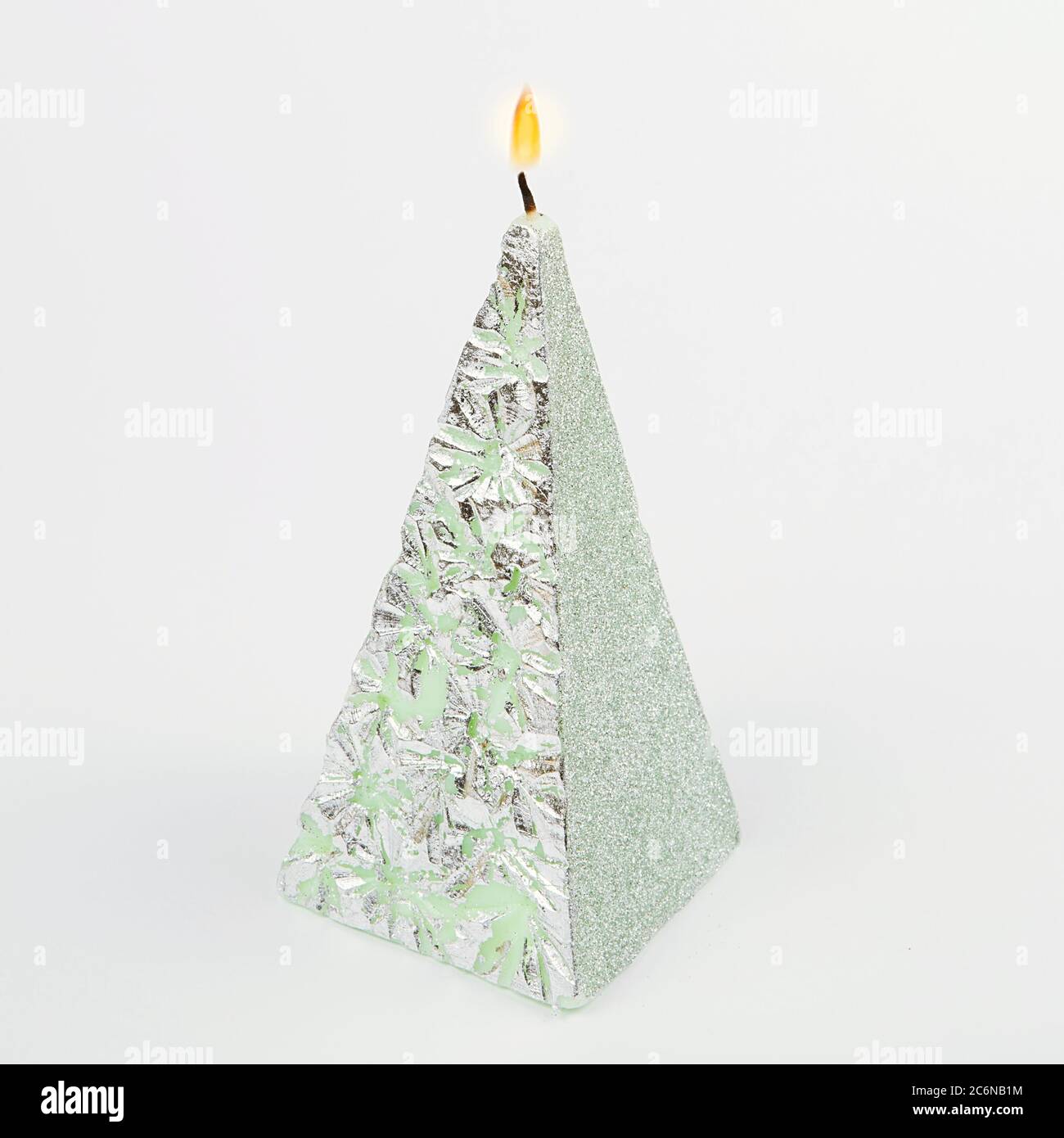 Decorative Handmade candle in the shape of a pyramid on white ...