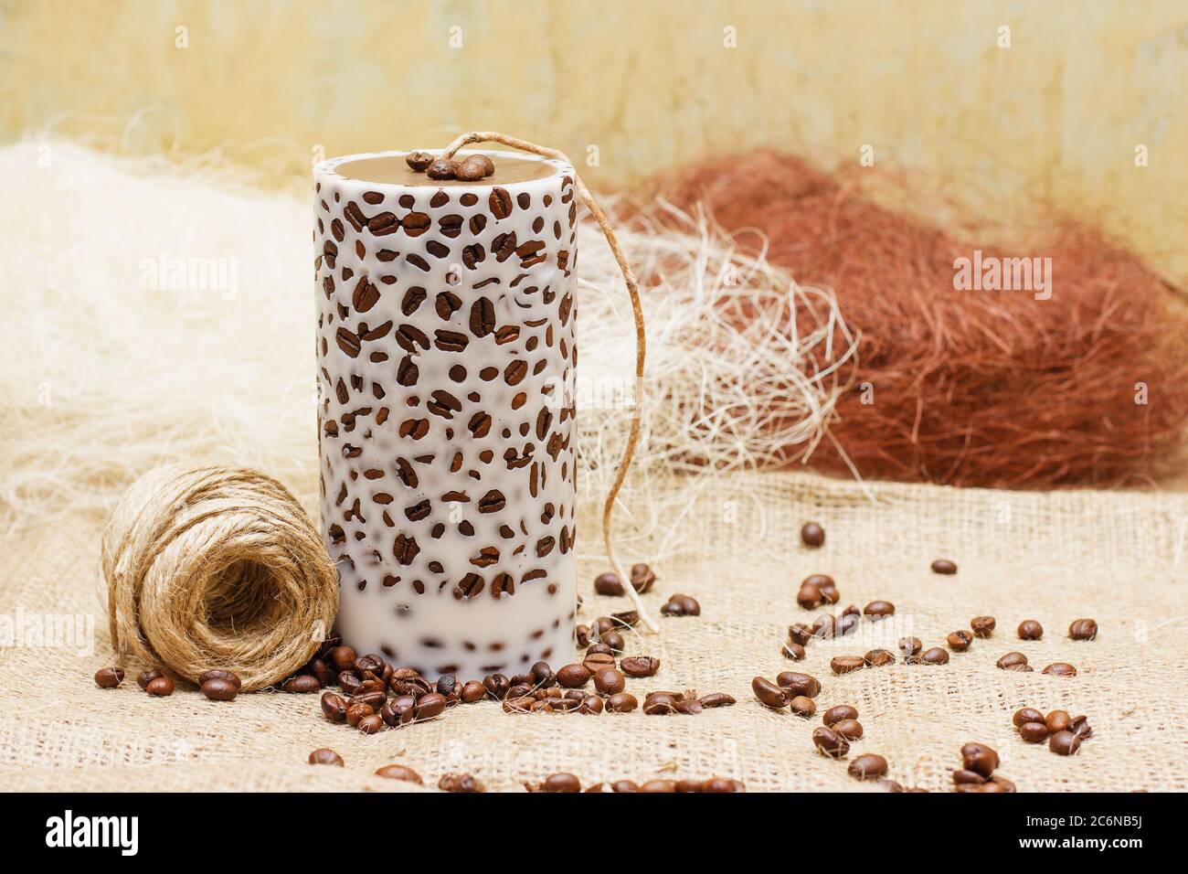 Beautiful Decorative Handmade candle with coffee beans on old sackcloth ...