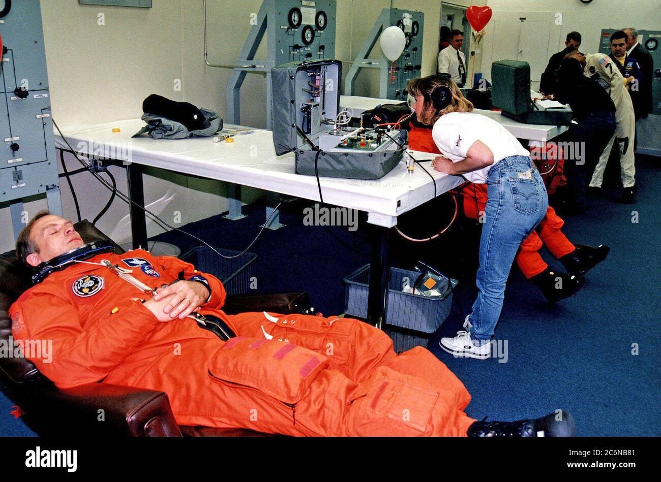 STS-82 Payload Commander Mark C. Lee relaxes for a moment after donning ...