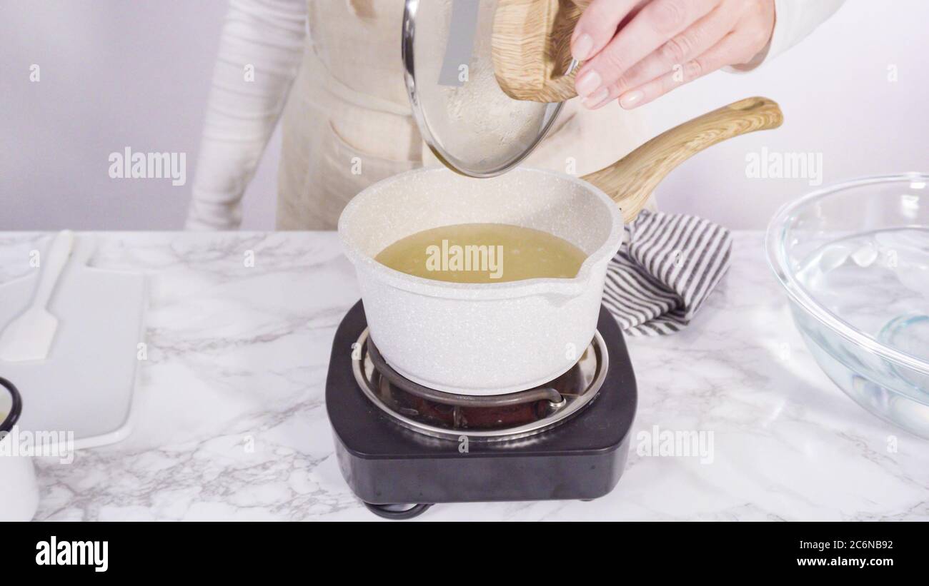 Step by step. Caramelizing sugar in a small cooking pot over the small ...