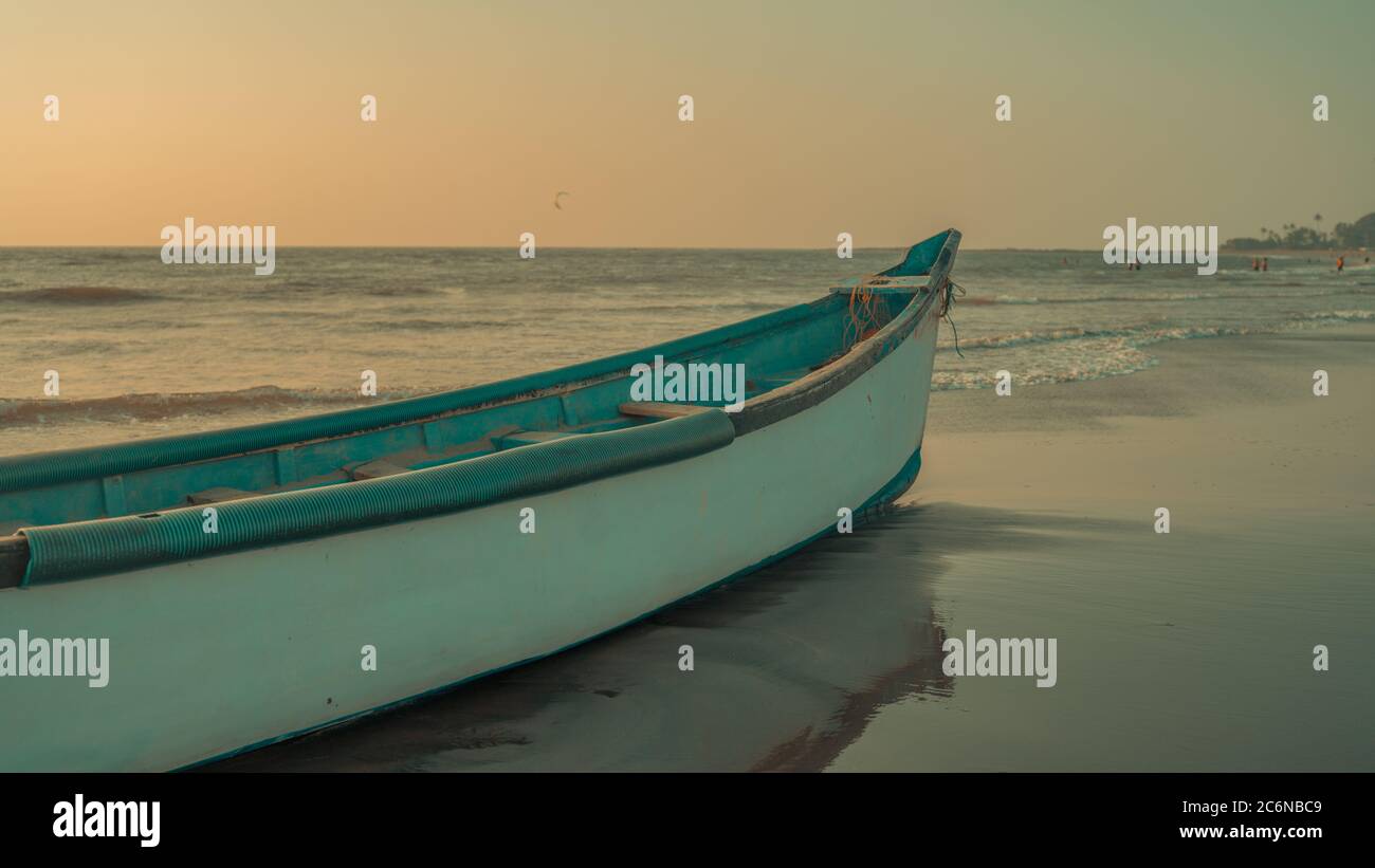 Empty boat on sandy beach in bright day. Large old white boat on sandy ...