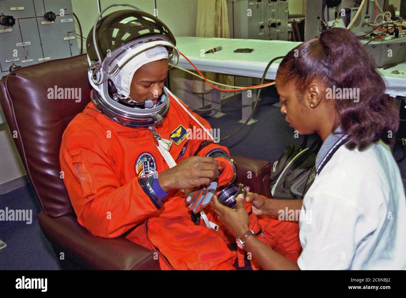 STS-85 Mission Specialist Robert L. Curbeam, Jr. looks down at his ...