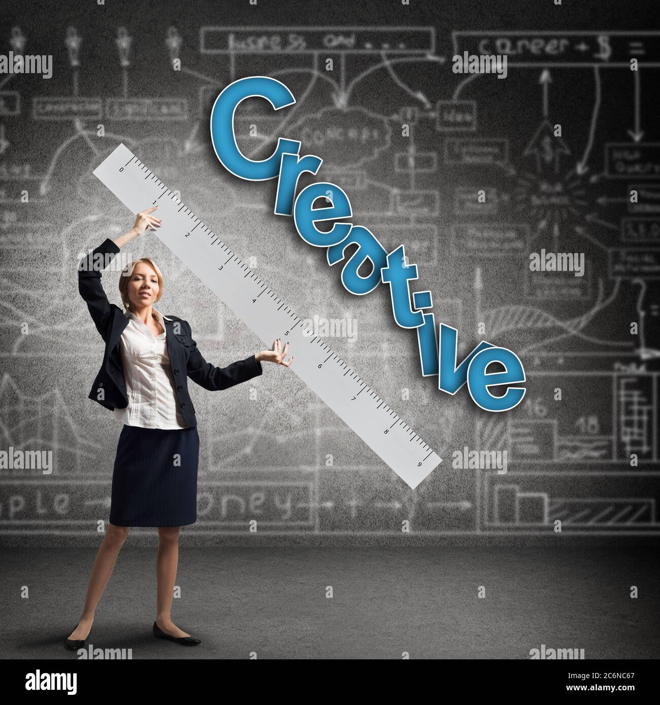 Woman in business suit holding big ruler Stock Photo - Alamy