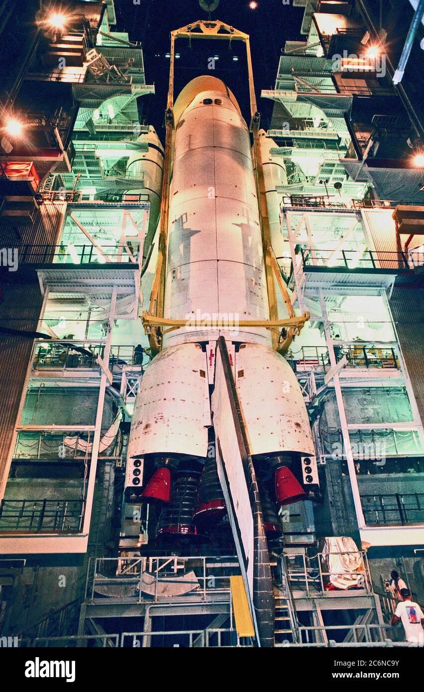 In the Vehicle Assembly Building, the orbiter Discovery is prepared for ...