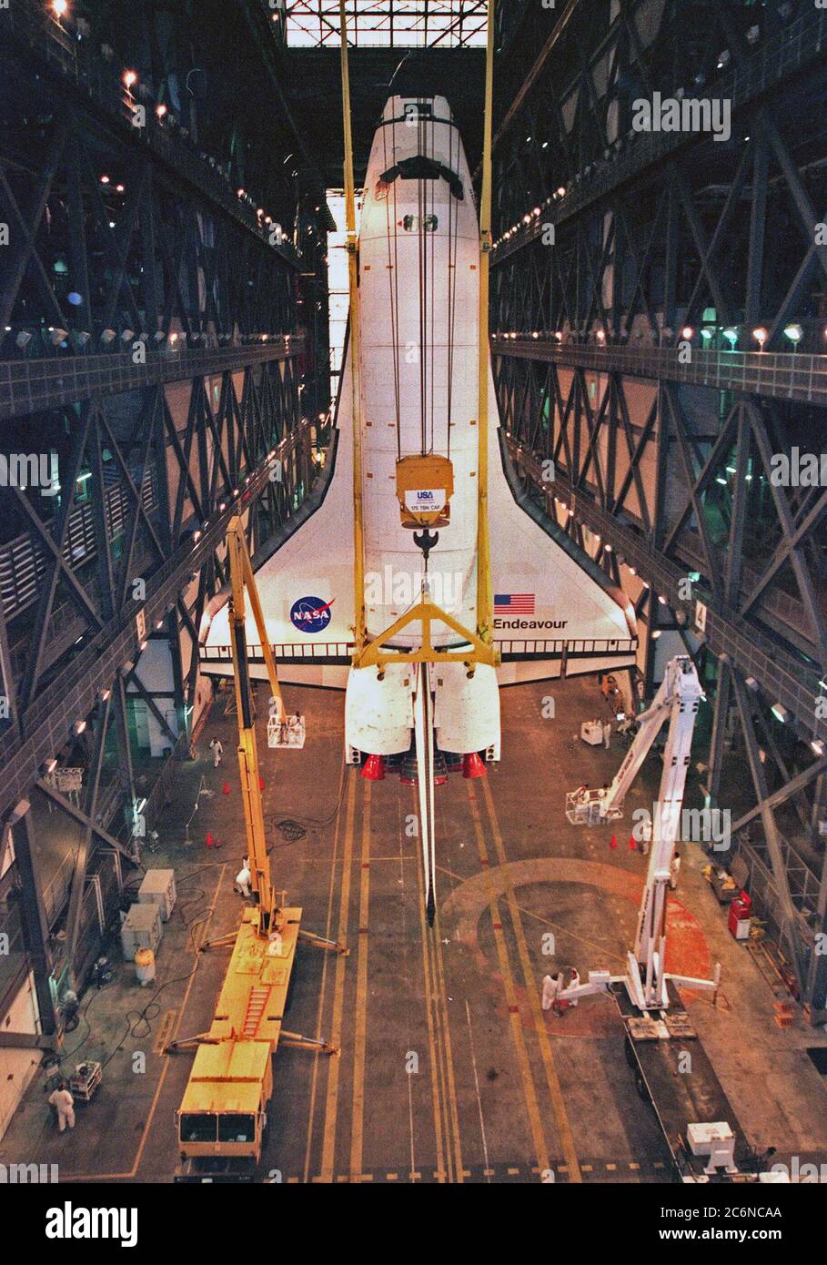 Orbiter Endeavour is suspended in a vertical position inside the ...