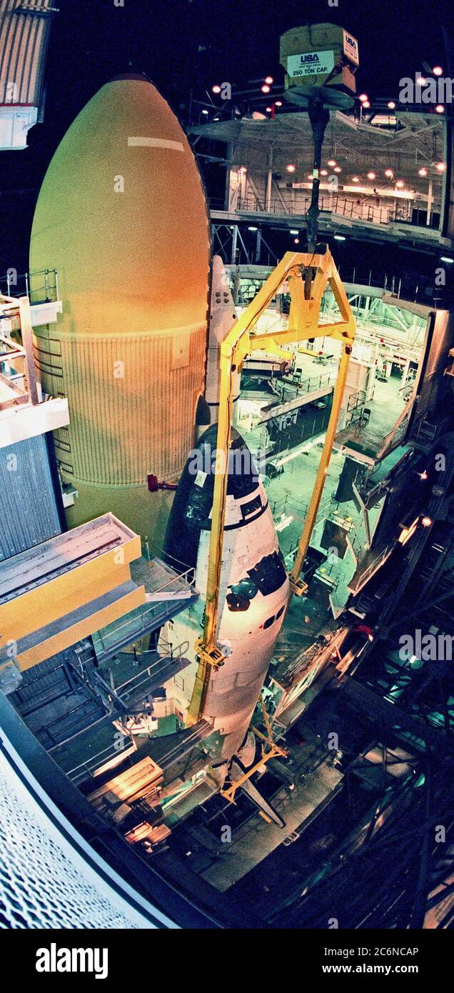 In the Vehicle Assembly Building, the orbiter Discovery is mated with ...