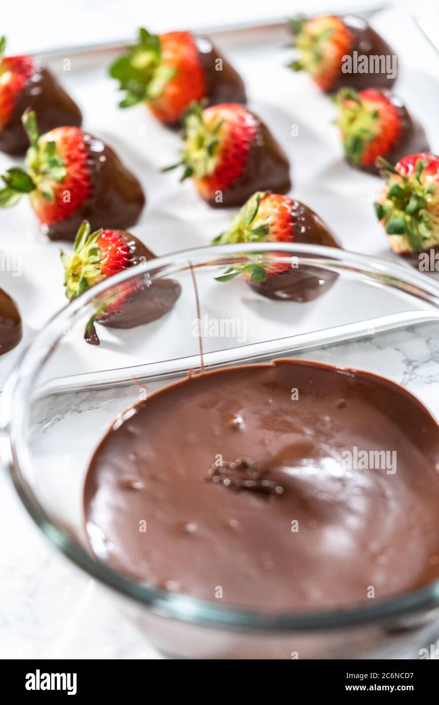 Making white and dark chocolate dipped strawberries Stock Photo - Alamy