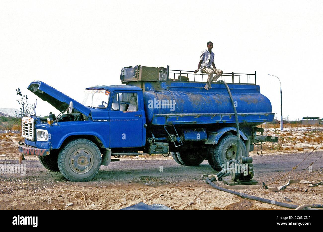1993 - A Somalian civilian delivers water to the US Marine compound ...