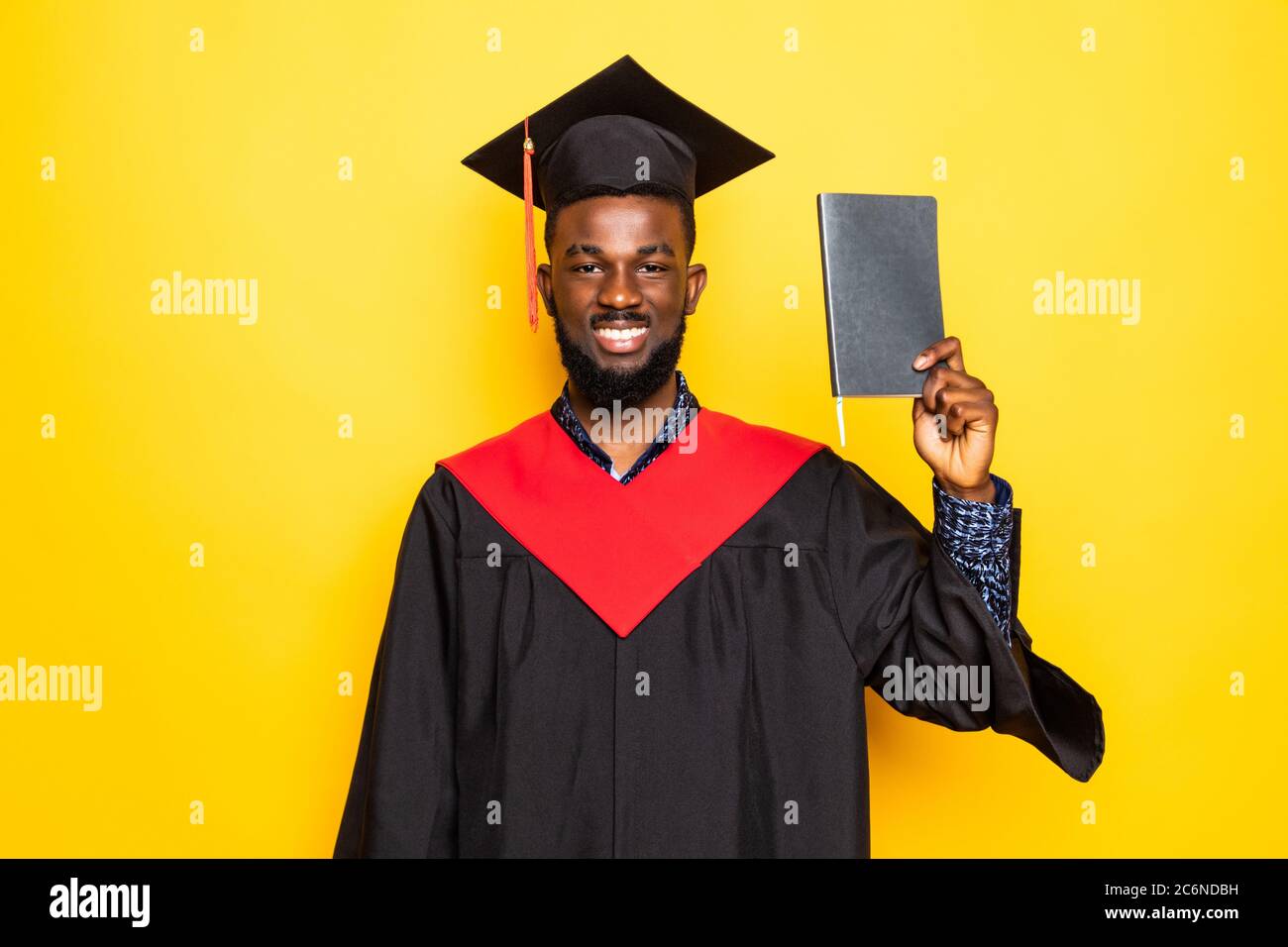 African American man college graduate with diploma on yellow background ...