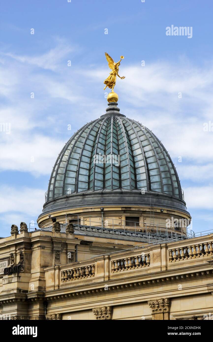 Golden angel or pheme sculpture on the glass dome top of the Albertinum ...