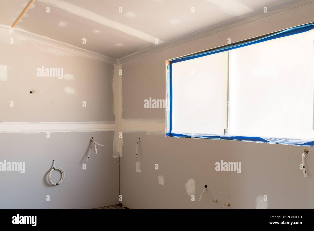 Renovating old house with new plasterboard in kitchen area with wiring ...